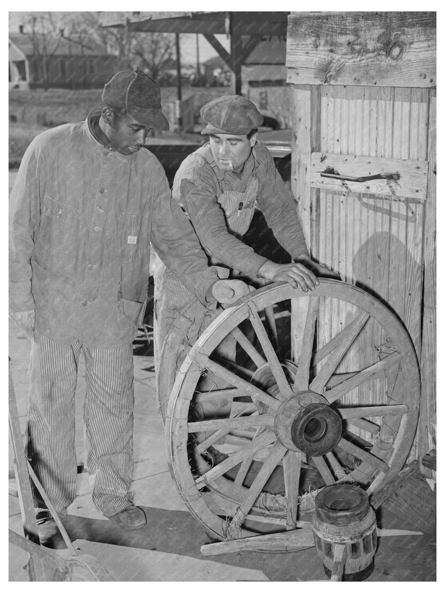 1940 Farmer and Blacksmith Examining Wagon Wheels in Oklahoma – KNOWOL